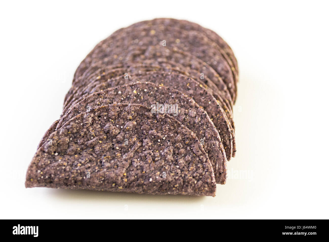 Blue corn taco shells on a white background Stock Photo - Alamy