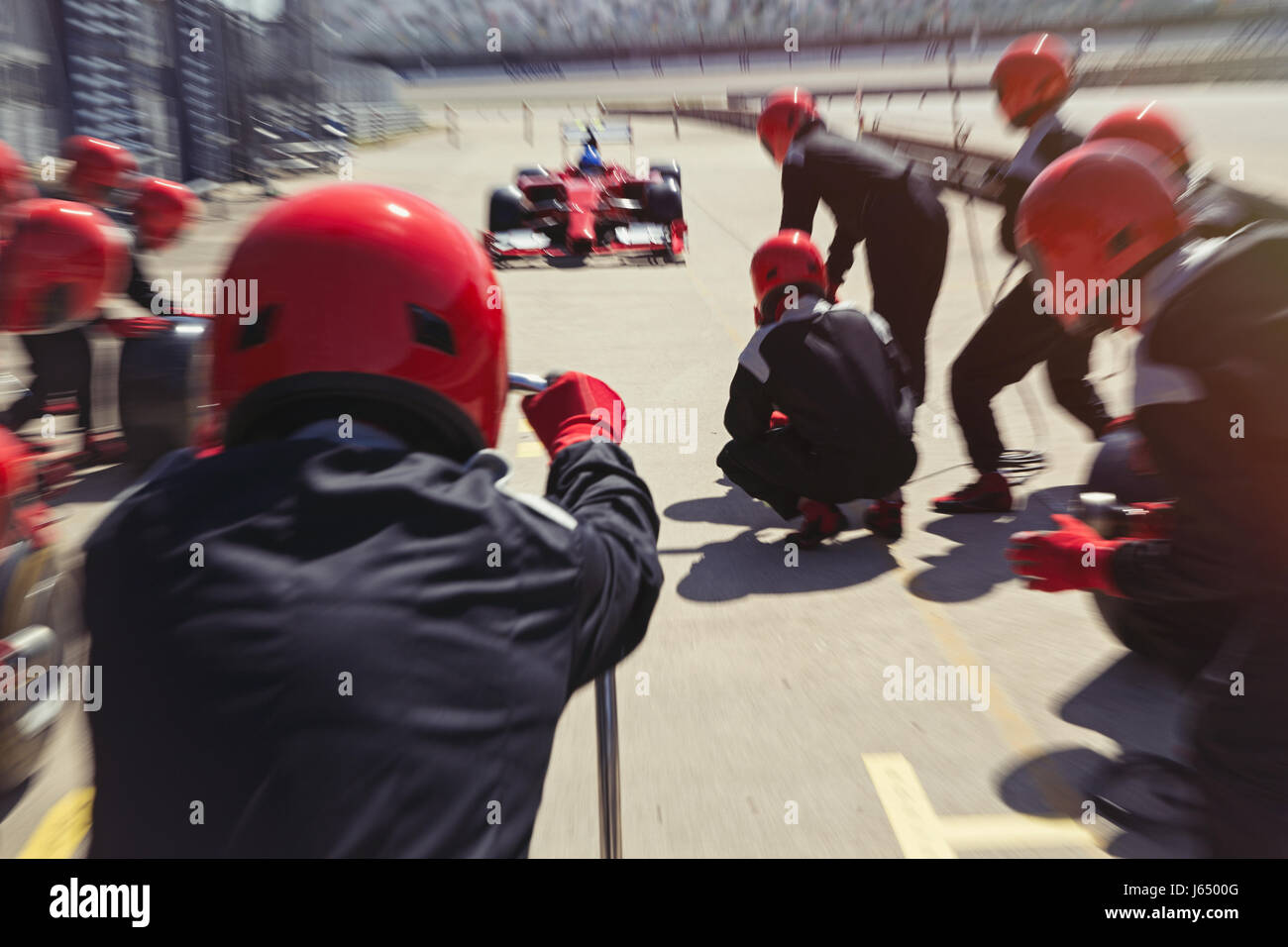 Pit crew ready for nearing formula one race car driver in pit lane Stock Photo - Alamy