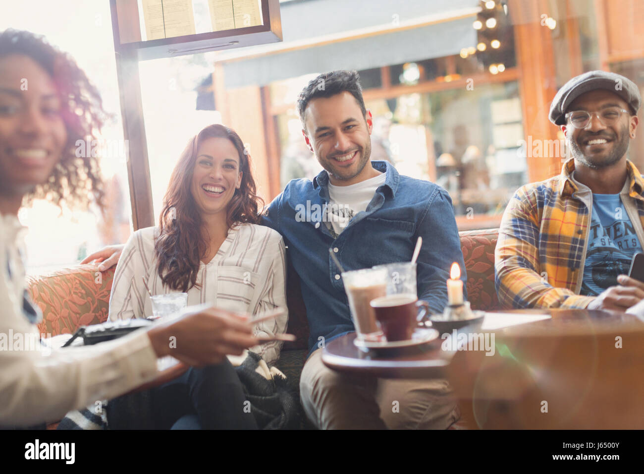 Portrait smiling friends hanging out in cafe Stock Photo - Alamy