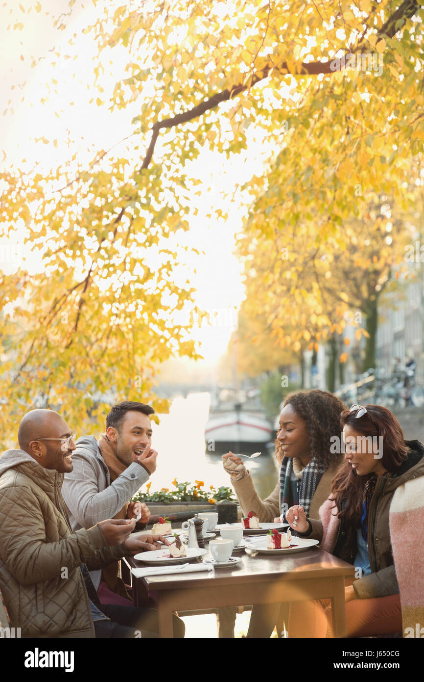 Group of friends drinking and eating together in a restaurant hi-res ...