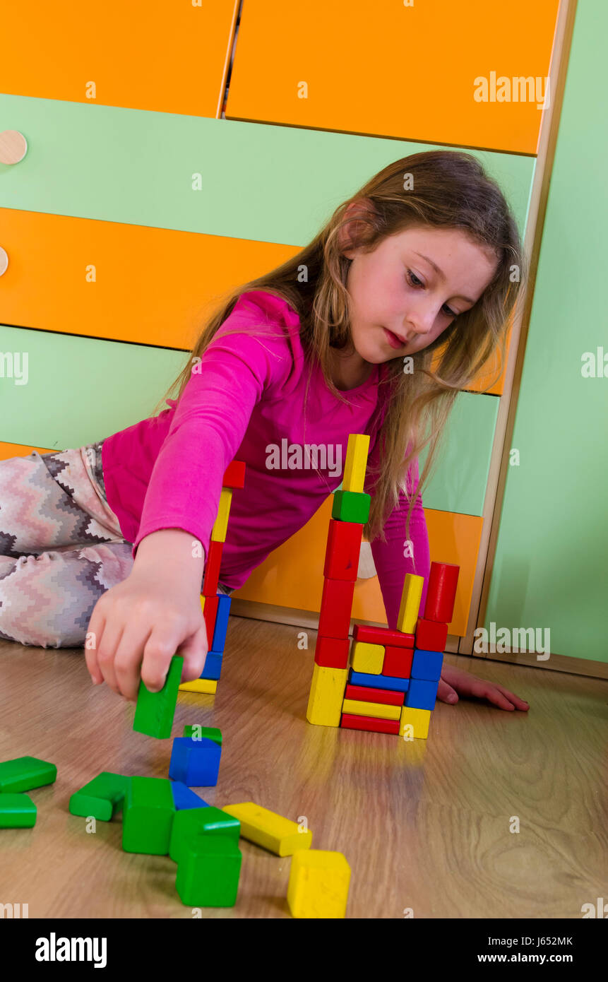 Little girl playing with construction toy blocks Stock Photo - Alamy