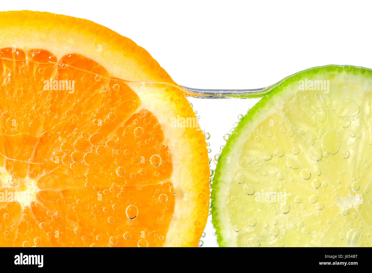 float fruit orange slices citrus lime swimmer water close food aliment macro Stock Photo - Alamy