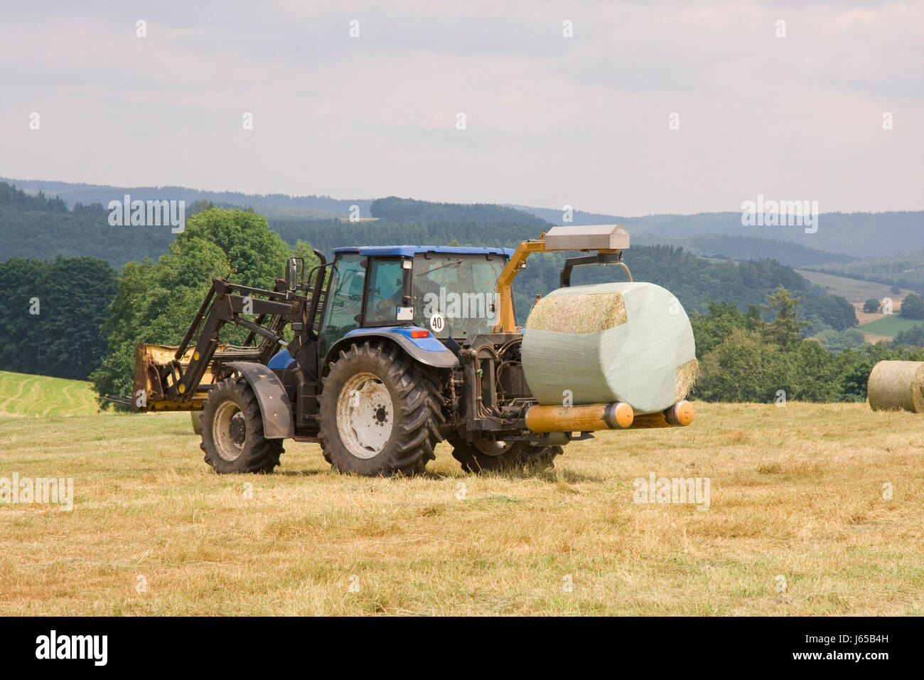 raw material hay-clench tractor hay packing packaging blue agrarian ...