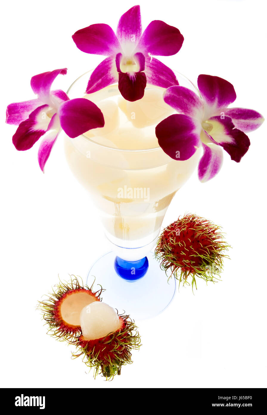 rambutan with fruit juice and orchid Stock Photo - Alamy
