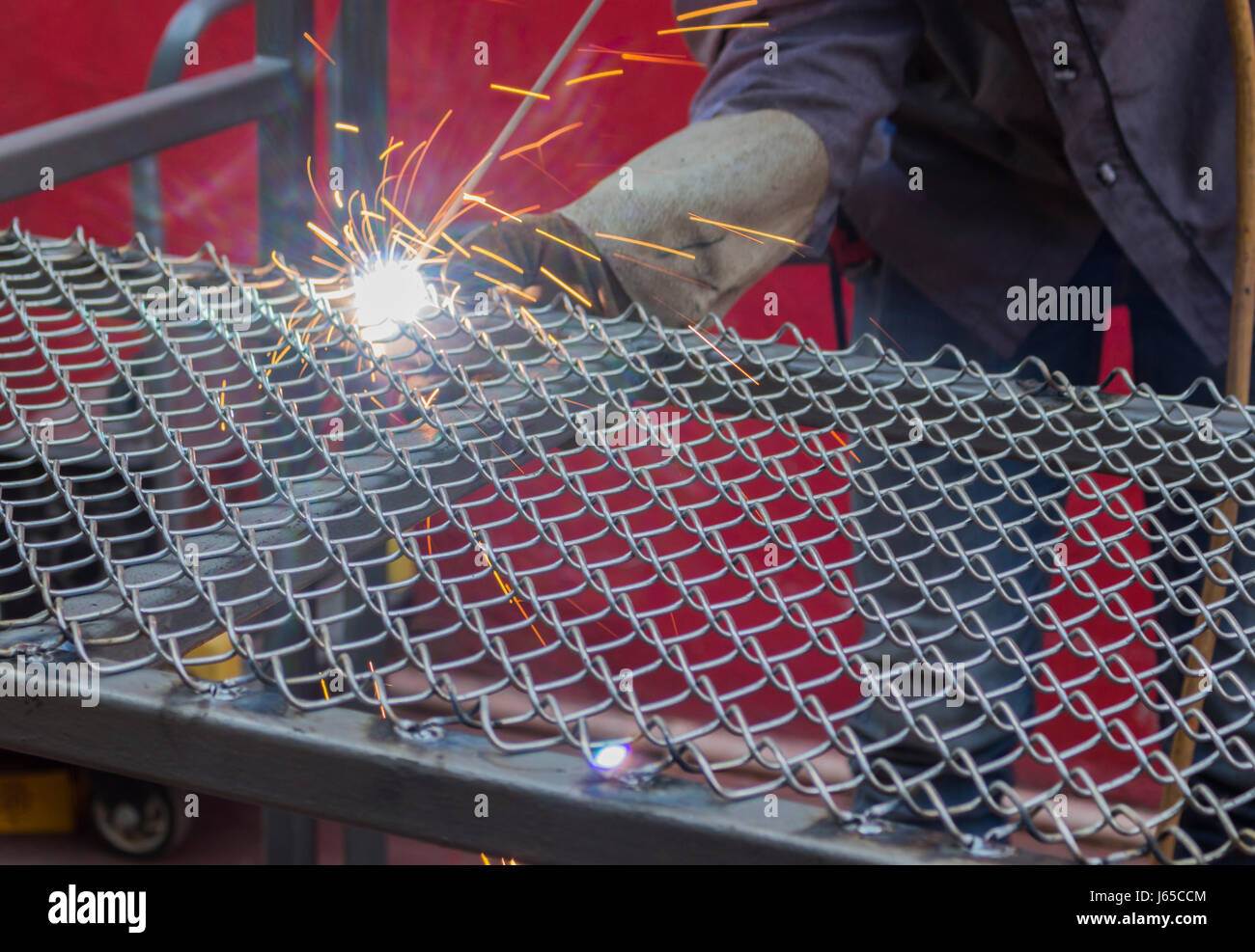 operator is welding a net with flash light and smoke Stock Photo - Alamy