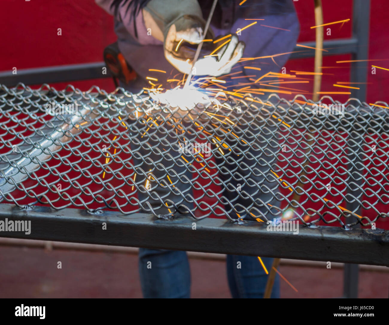 operator is welding a net with flash light and smoke Stock Photo - Alamy