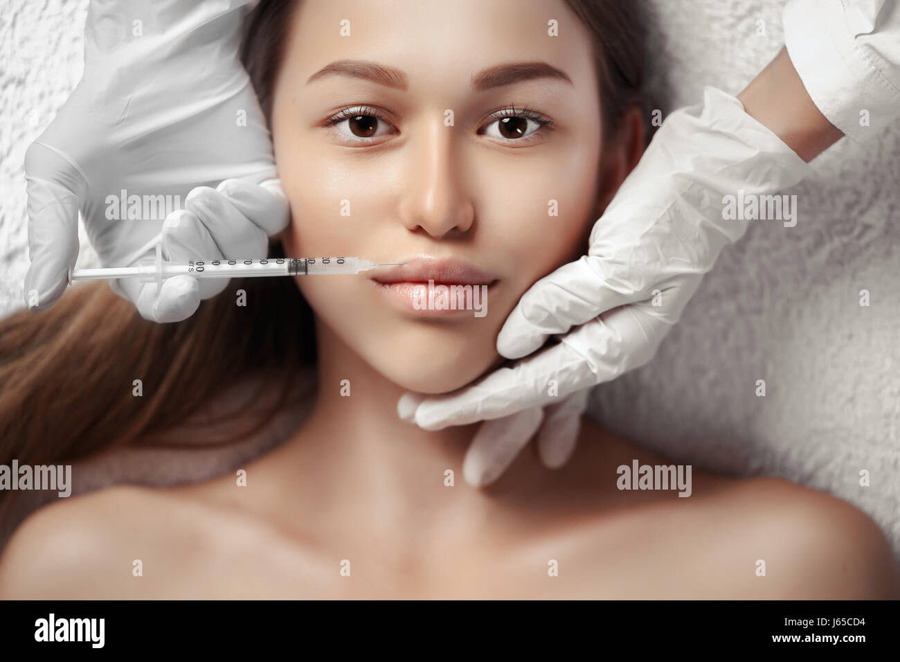 Portrait of woman getting cosmetic injection Stock Photo - Alamy