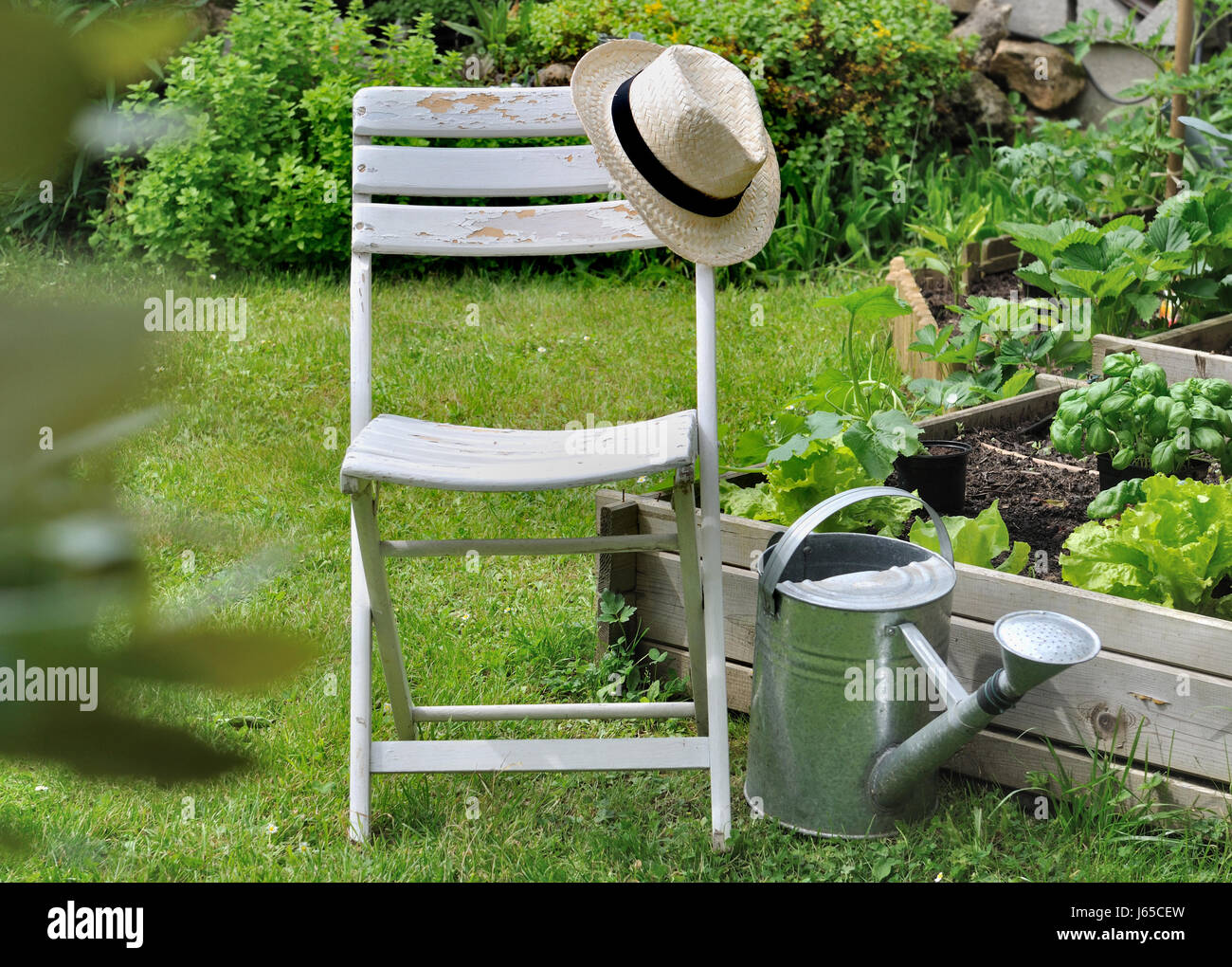 hat on a chair in a garden Stock Photo - Alamy