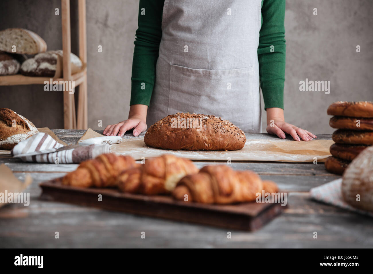 Cropped photo of young lady baker standing near bread Stock Photo - Alamy