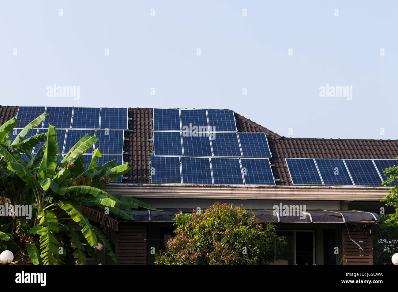 Solar panels on roof of a house with blue sky background Stock Photo ...