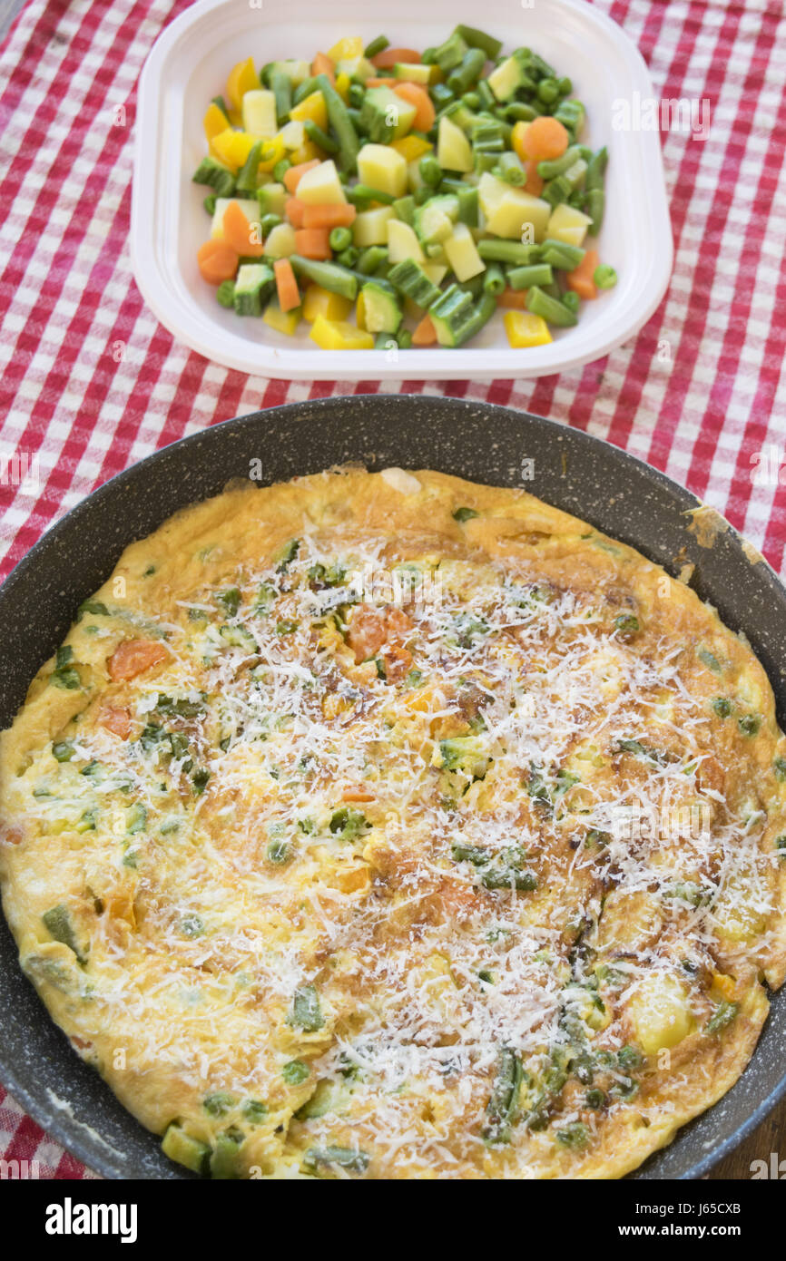 omelette with steamed vegetables in cubes and parmesan cheese Stock ...