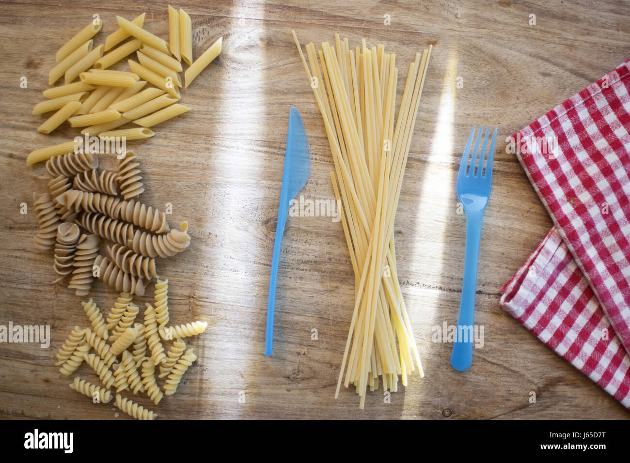 different kinds of raw pasta with rays of light intersecting Stock ...