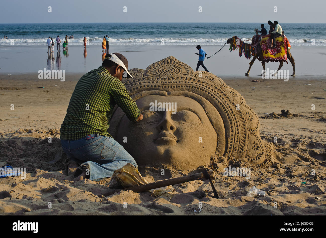 Sand artist at work, beach, bay of Bengal ( India). The sculpture ...