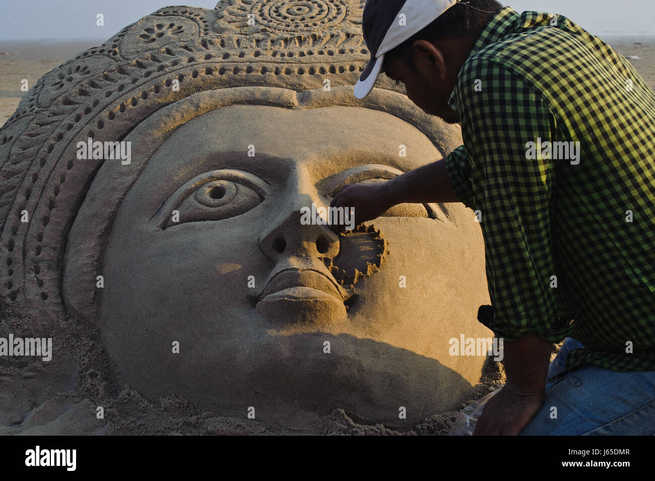 Sand artist at work, beach, bay of Bengal ( India). The sculpture ...