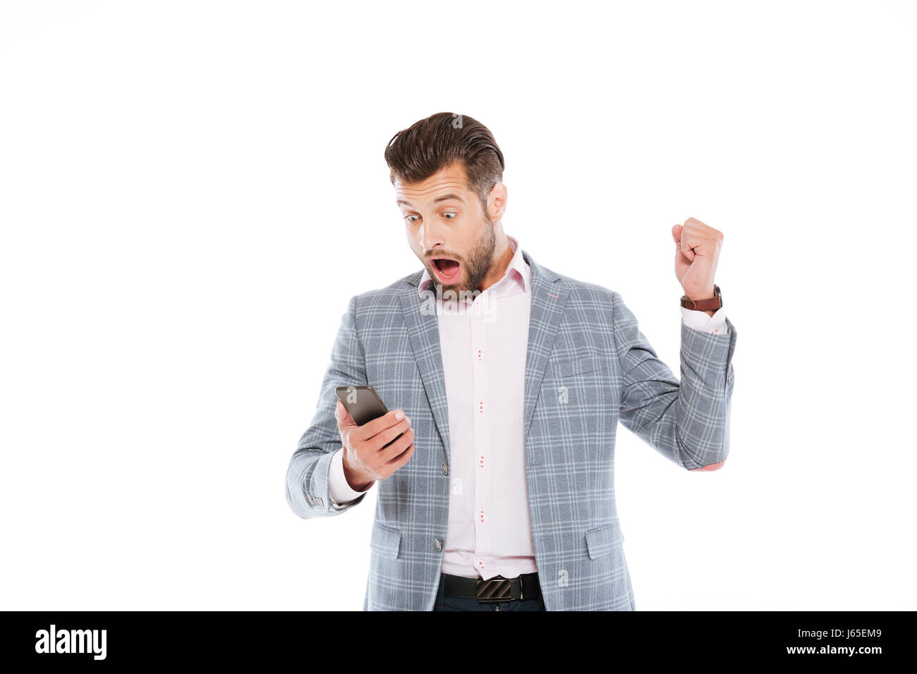 Image of shocked young man standing isolated over white background and ...