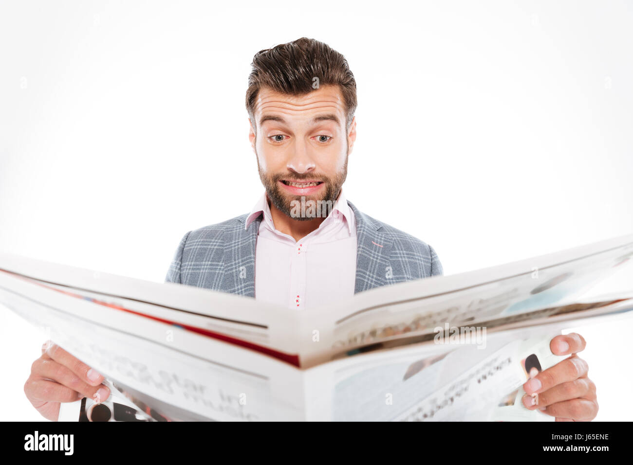 Image of confused young man standing isolated over white background ...