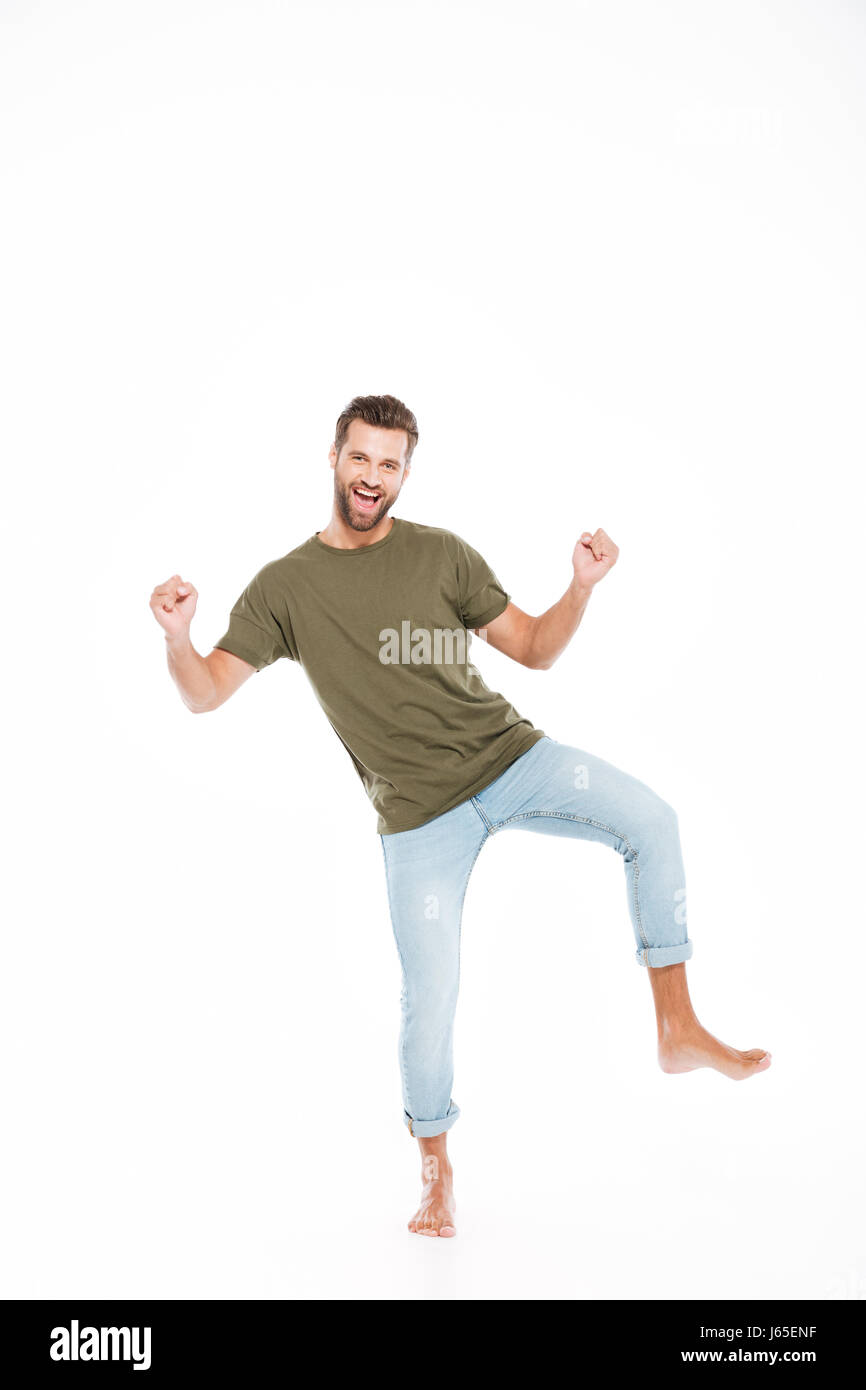 Image of happy young man standing isolated over white background ...