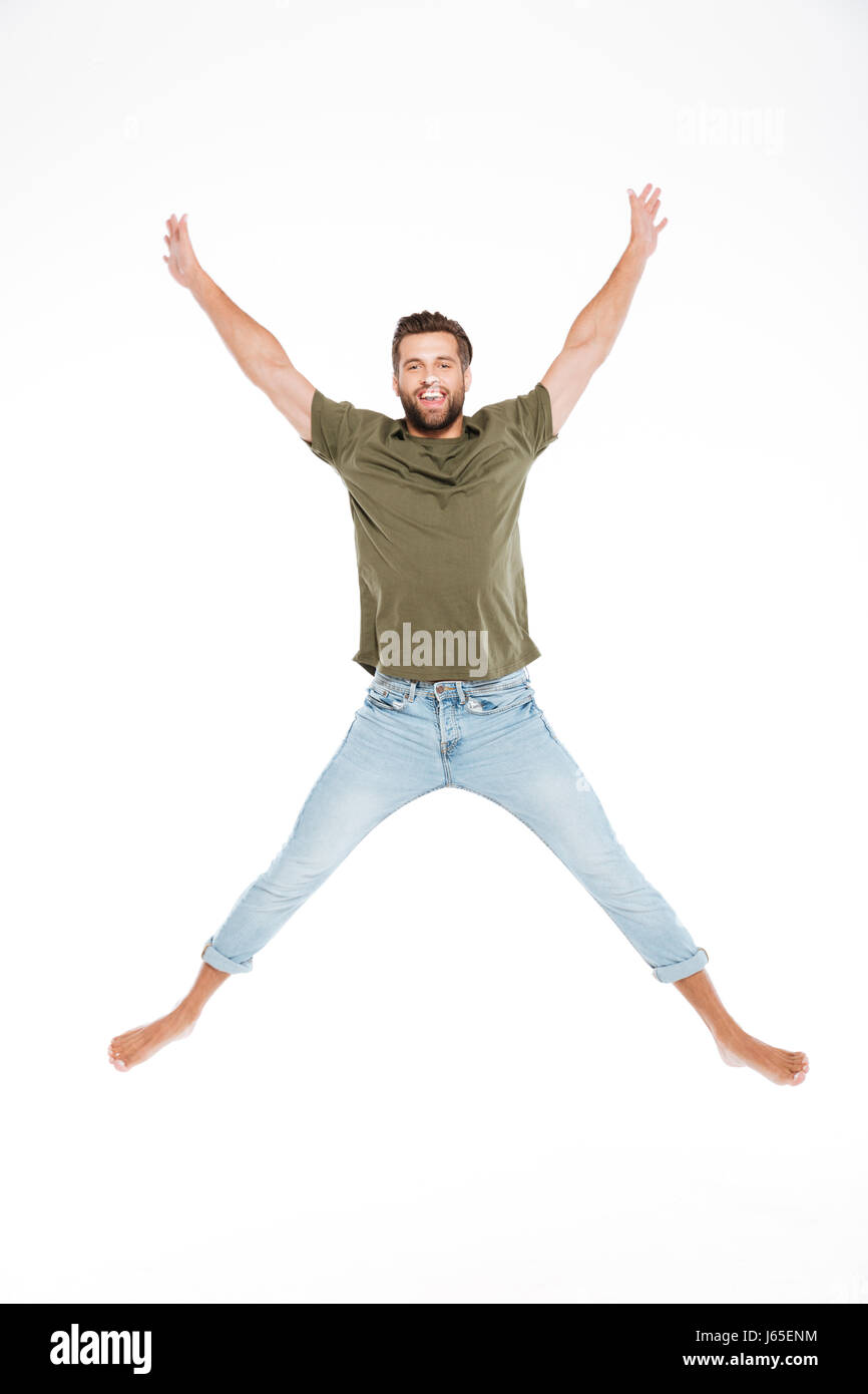 Image of happy young man jumping isolated over white background ...