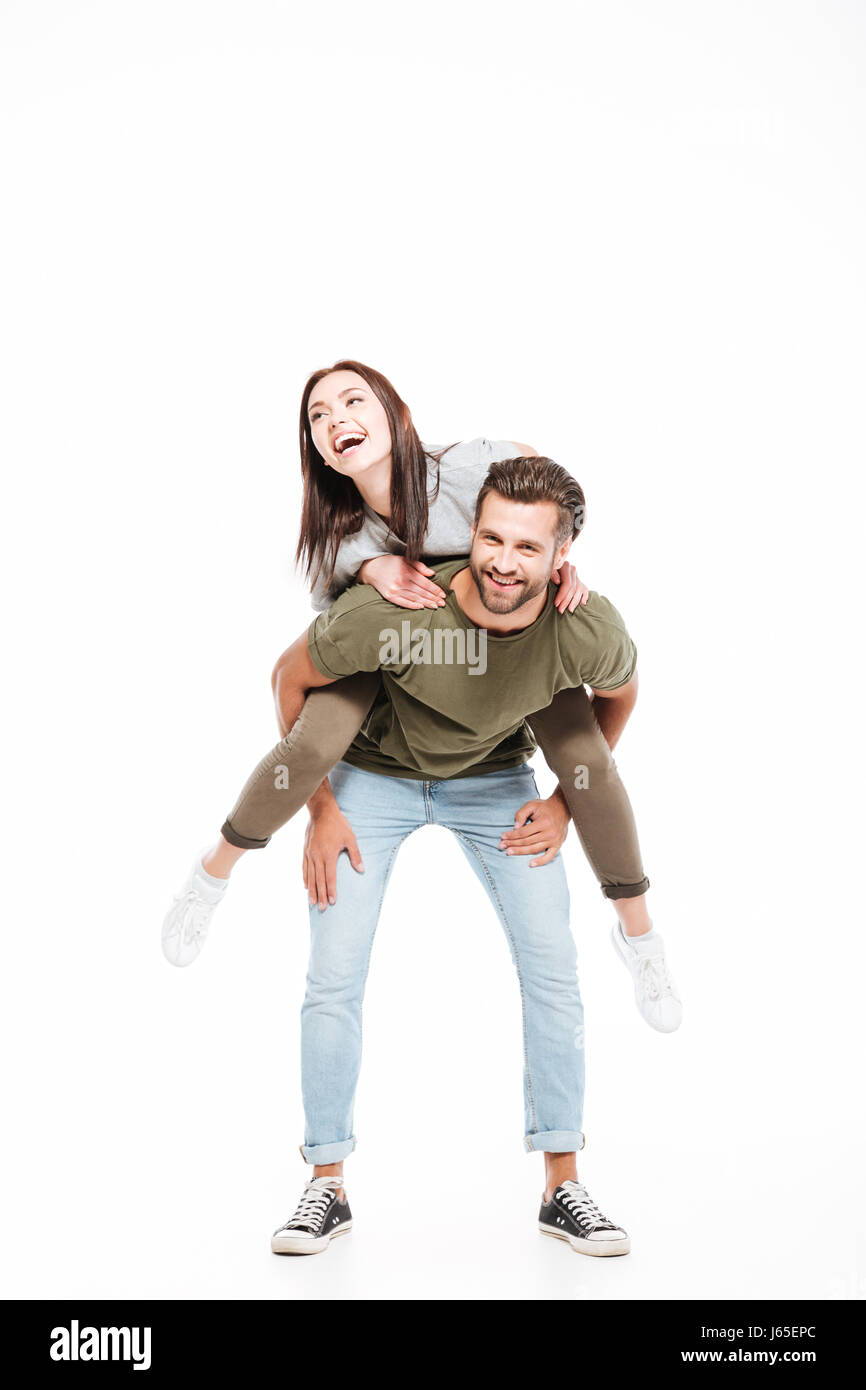 Cheerful woman sitting on back of her strong man isolated Stock Photo ...