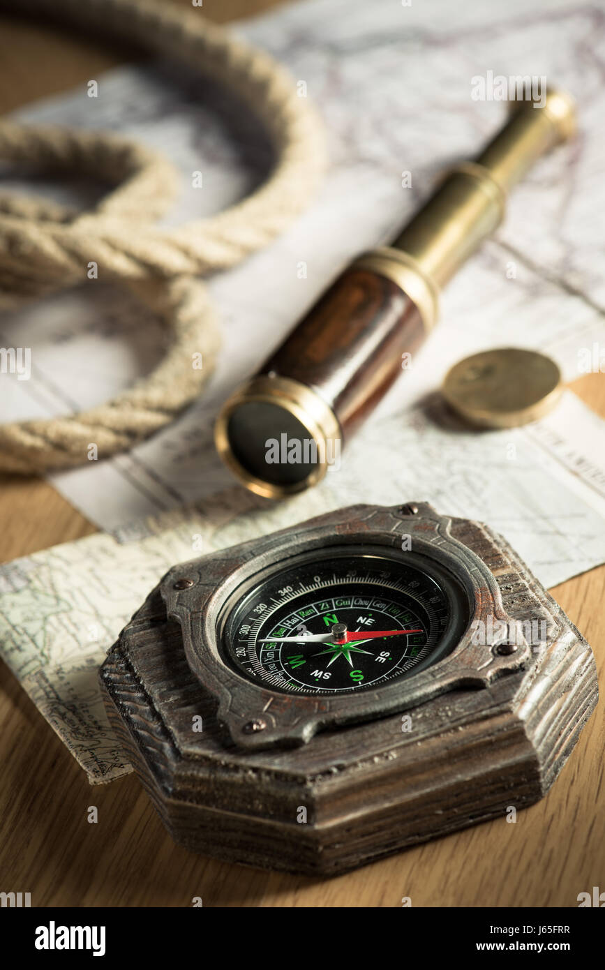 Old map with brass telescope, compass and rope on background Stock ...