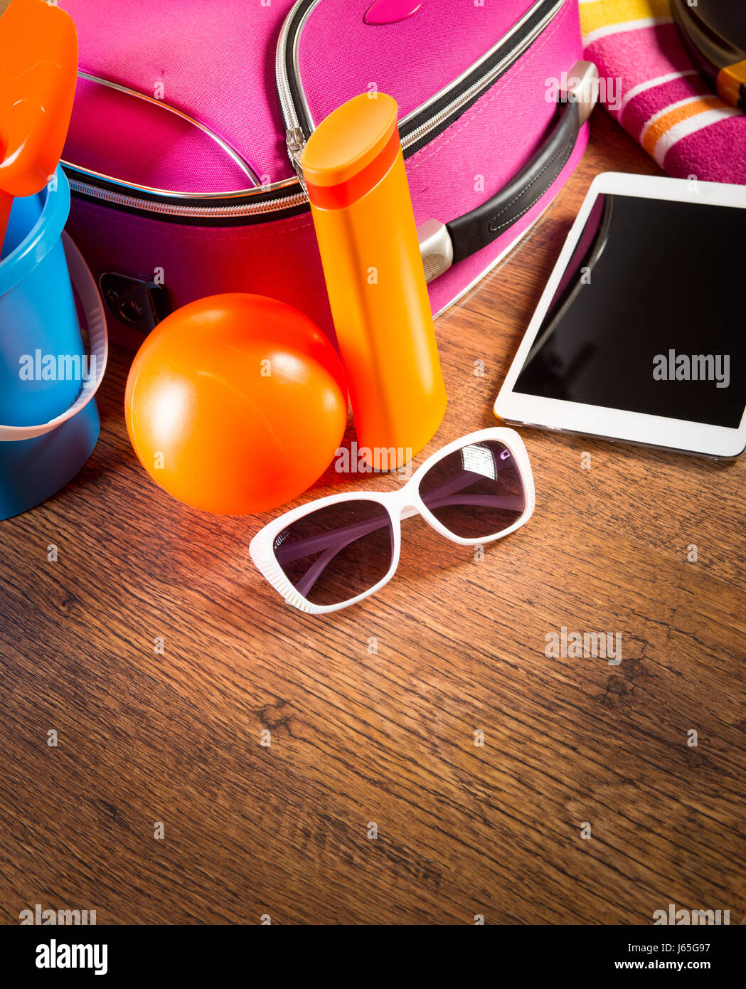 Leaving for vacations on the beach with digital tablet and colorful ...