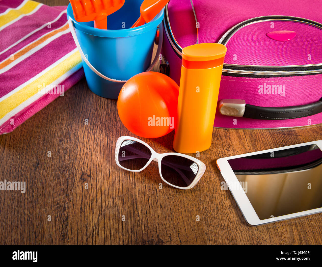 Leaving for vacations on the beach with digital tablet and colorful ...