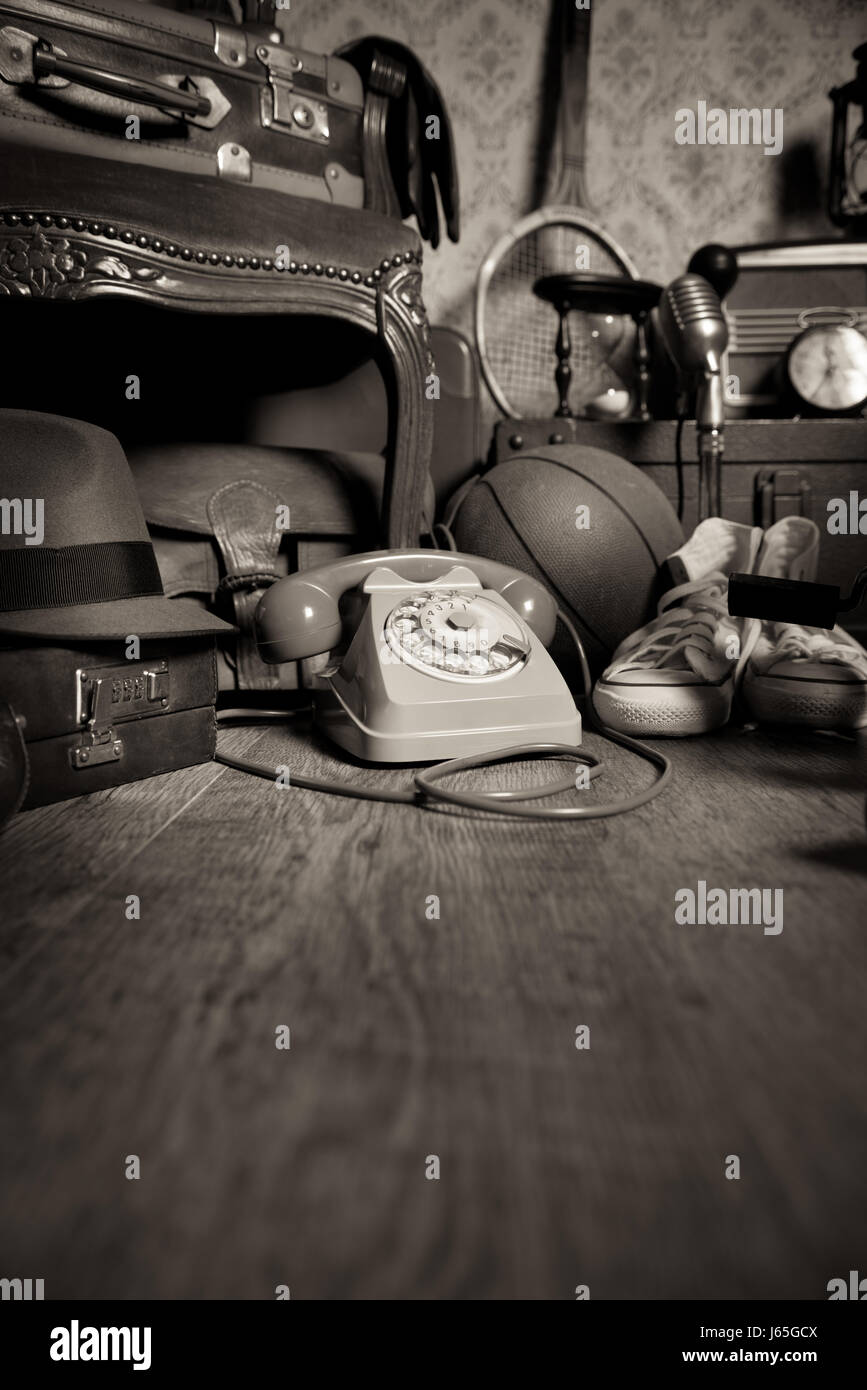 Group of vintage objects on attic hardwood floor, including old toys ...