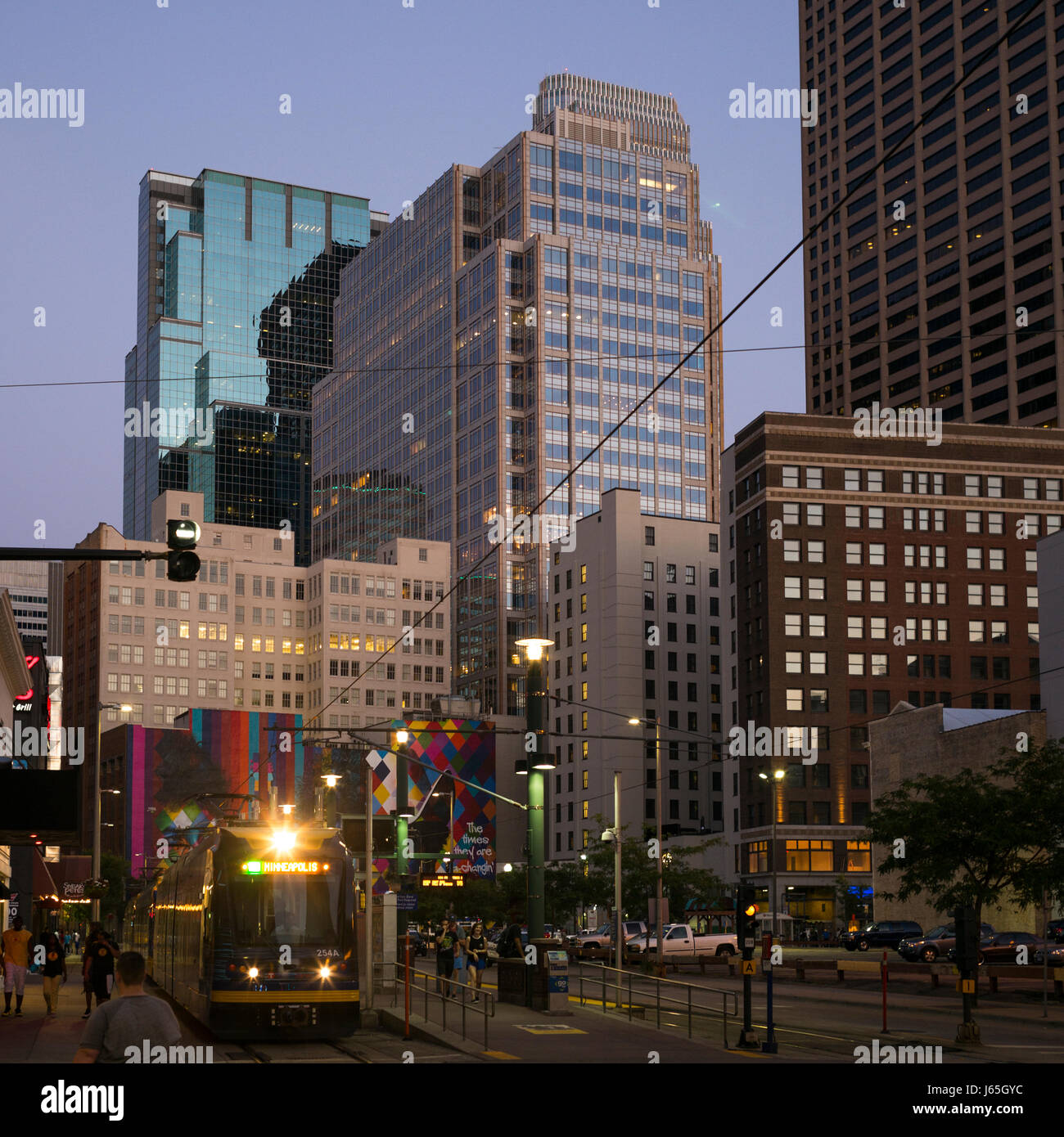 Tram on street amidst modern office buildings at Downtown Minneapolis ...