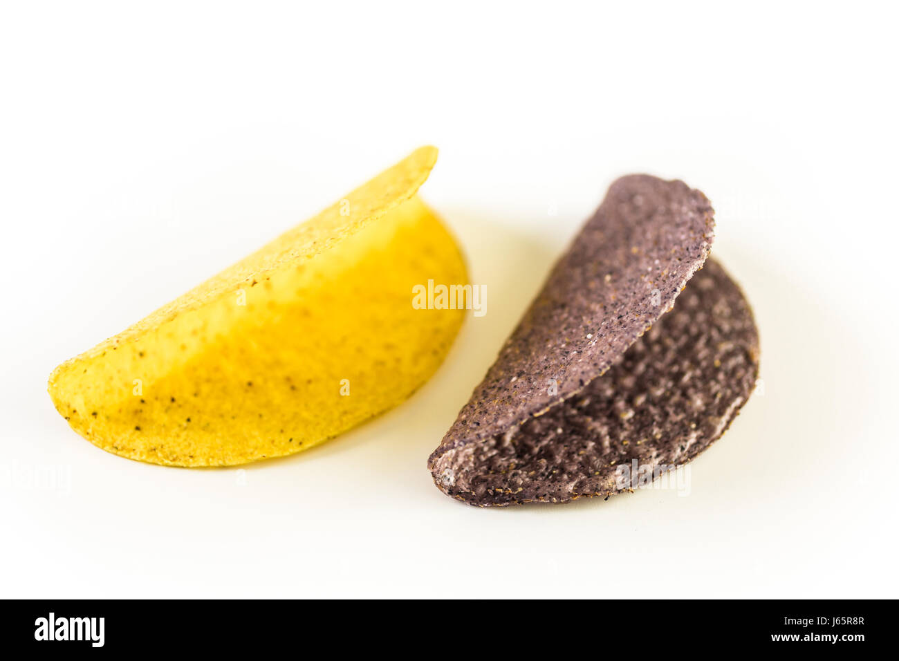Blue and yellow corn taco shells on a white background Stock Photo - Alamy