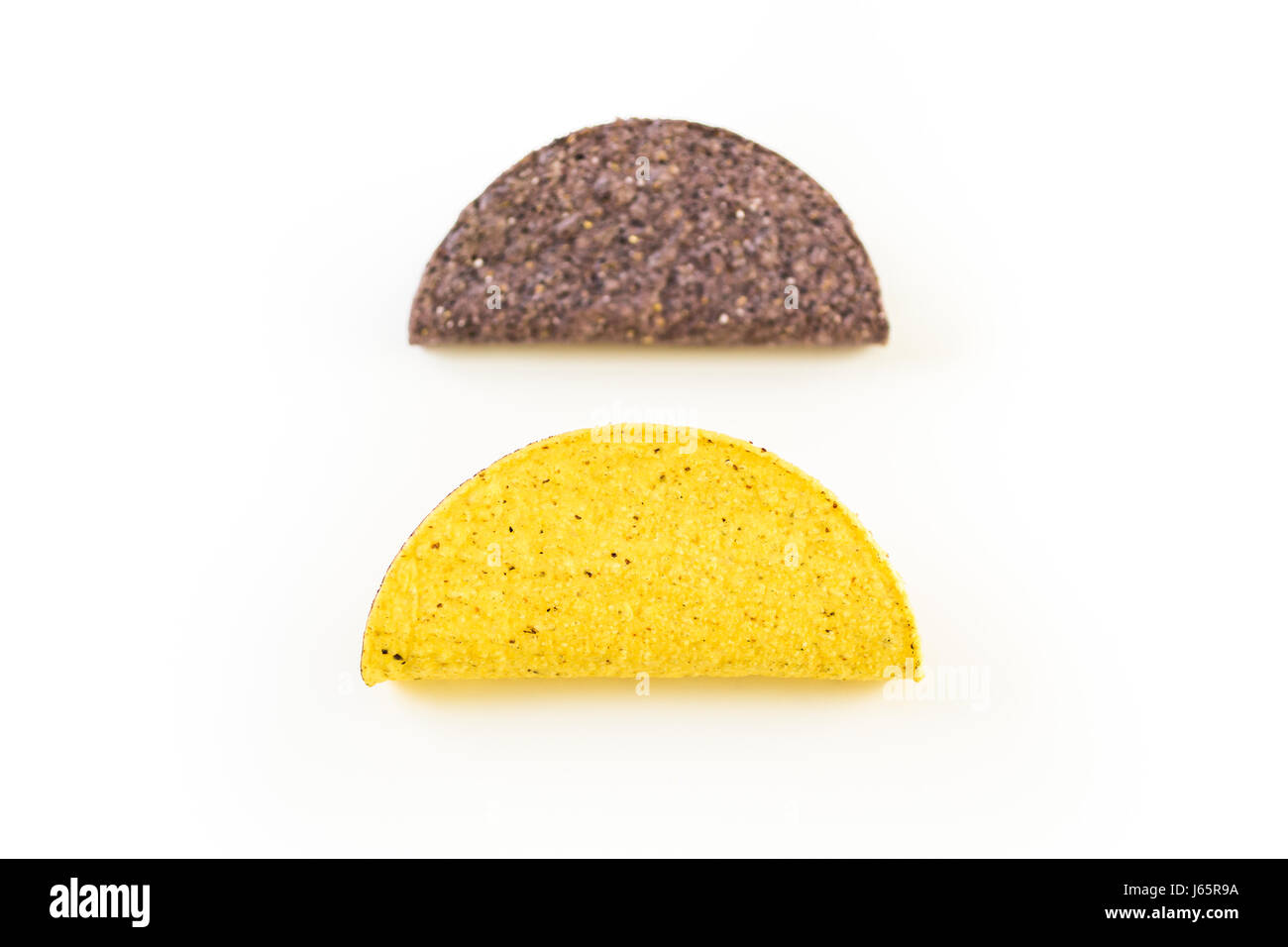 Blue and yellow corn taco shells on a white background Stock Photo - Alamy