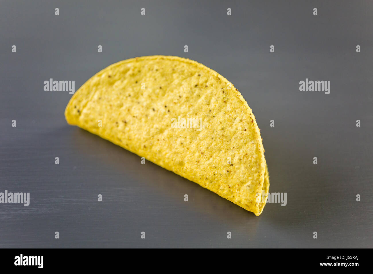 Yellow corn taco shells on a gray background Stock Photo - Alamy