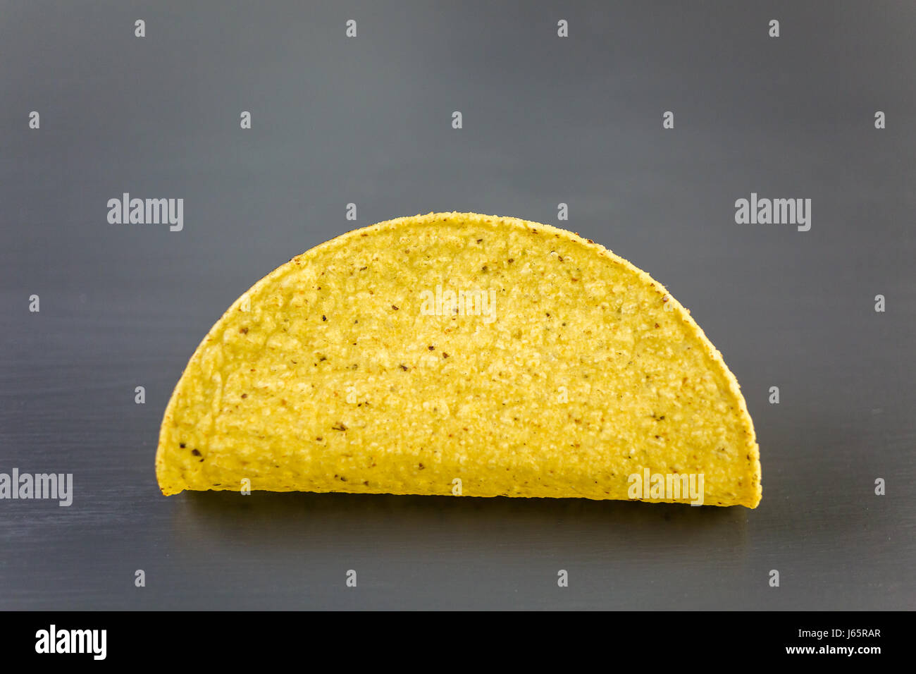 Yellow corn taco shells on a gray background Stock Photo - Alamy