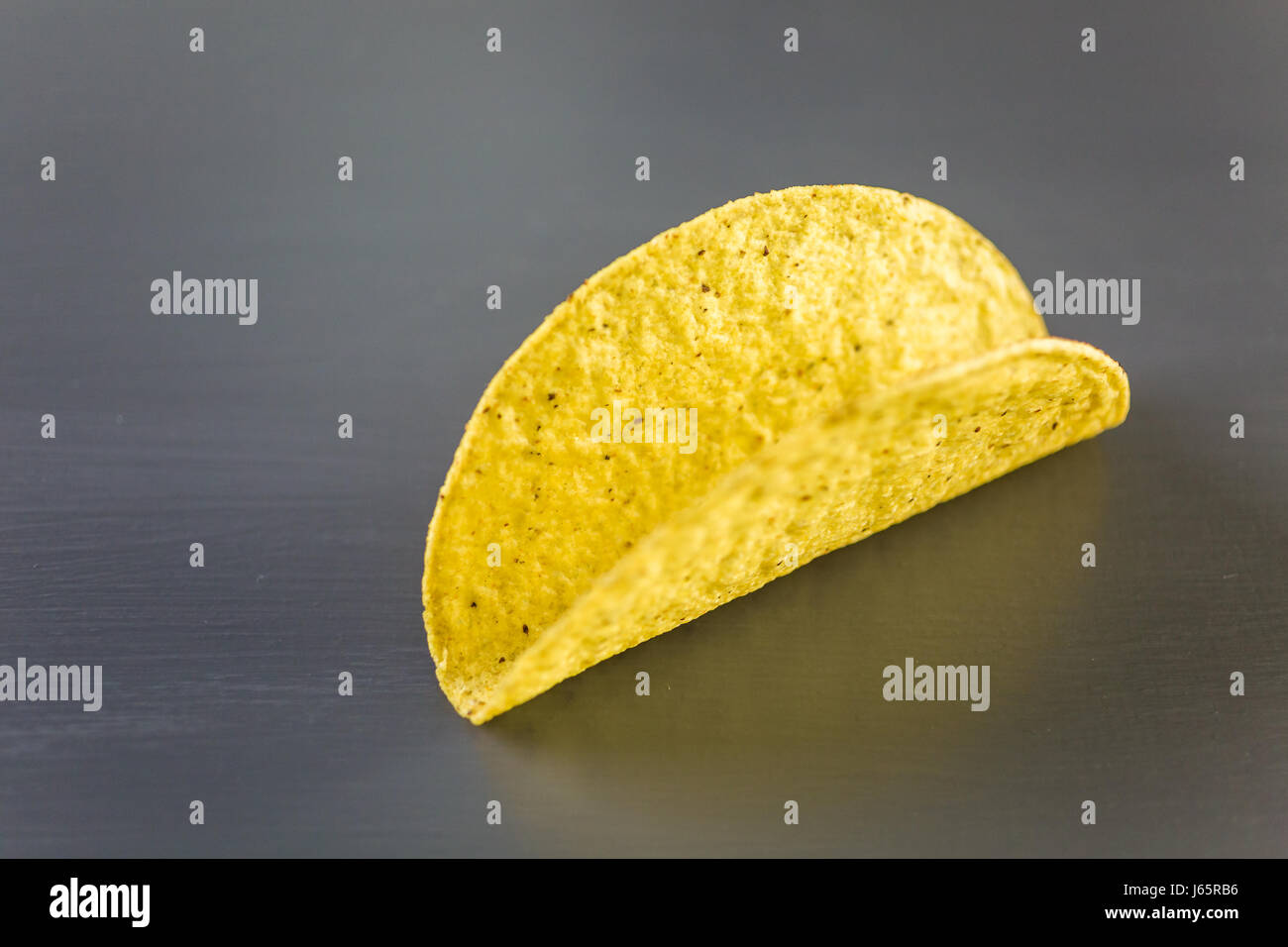 Yellow corn taco shells on a gray background Stock Photo - Alamy