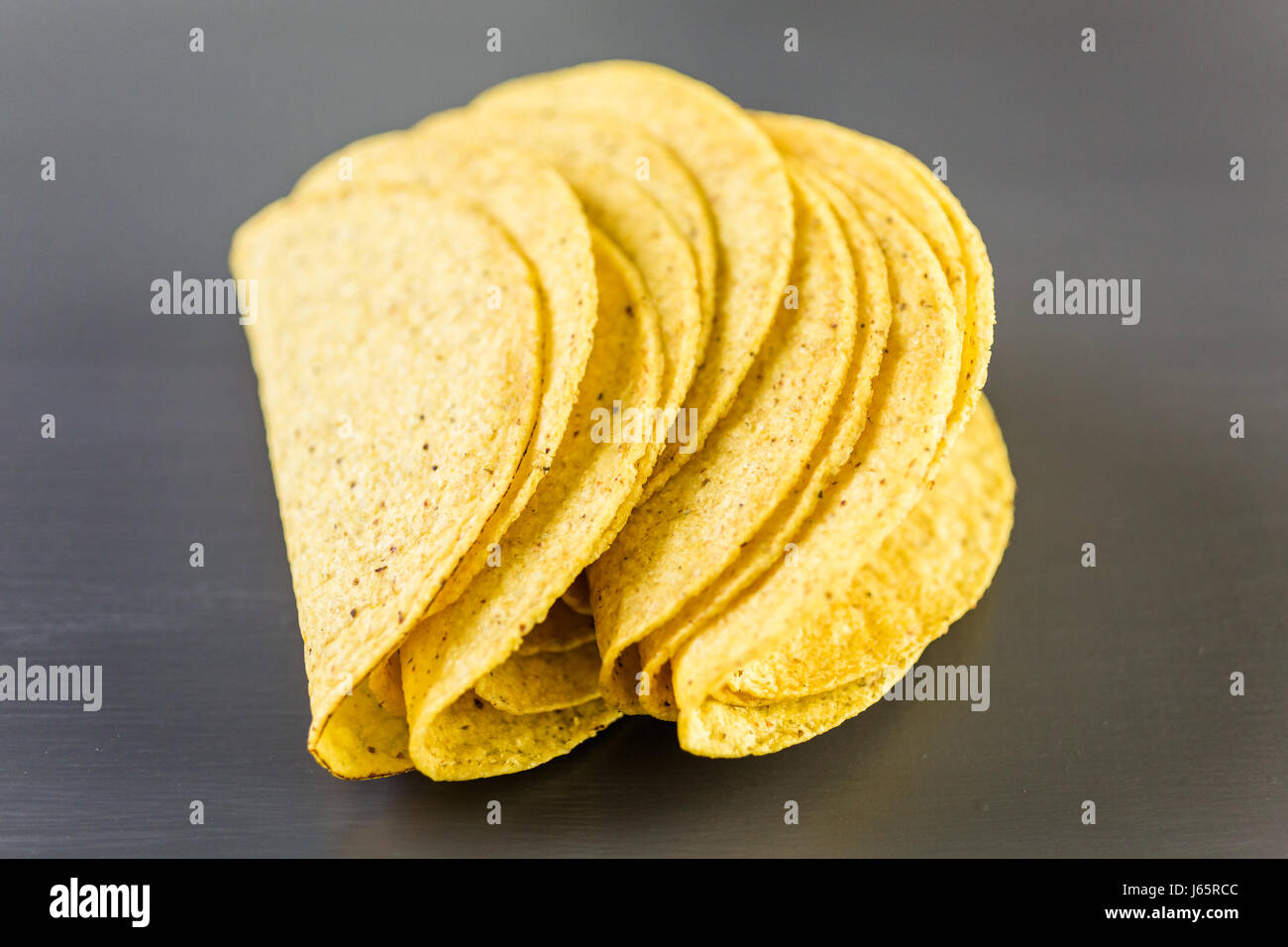 Yellow corn taco shells on a gray background Stock Photo - Alamy
