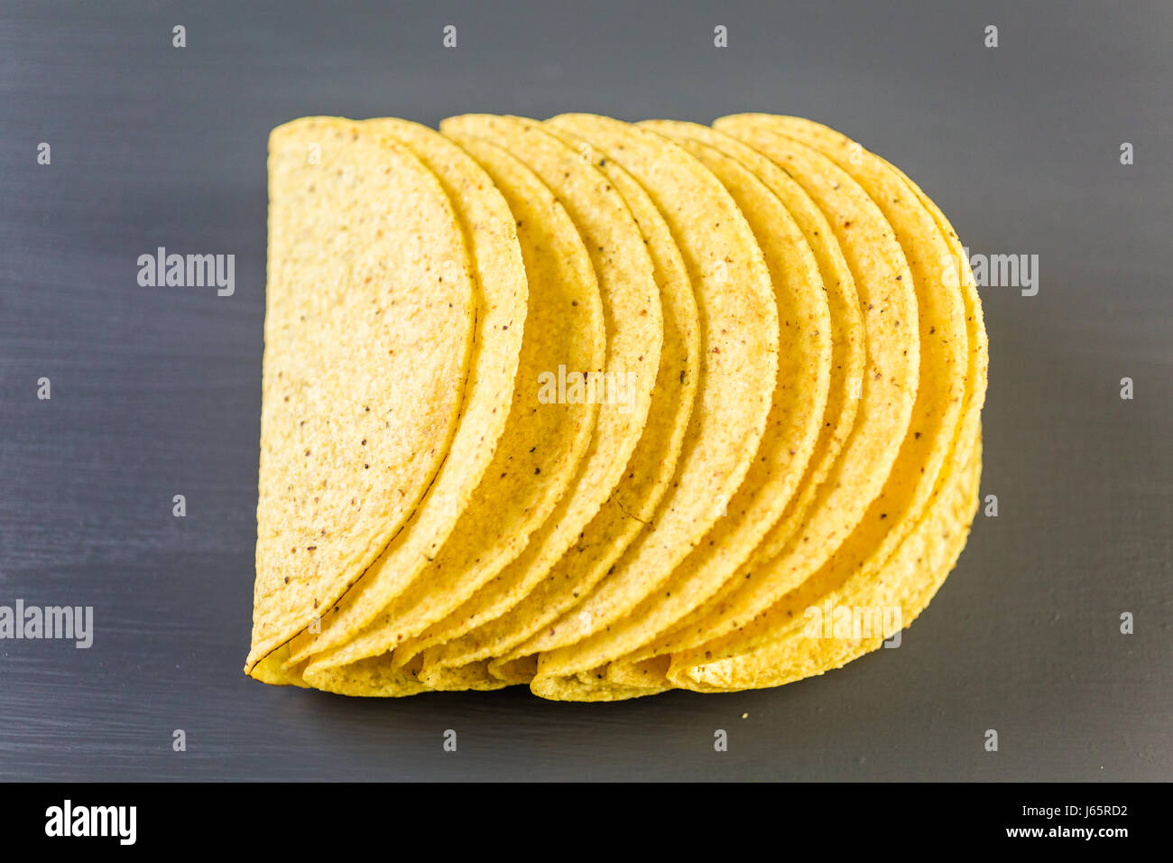 Yellow corn taco shells on a gray background Stock Photo - Alamy