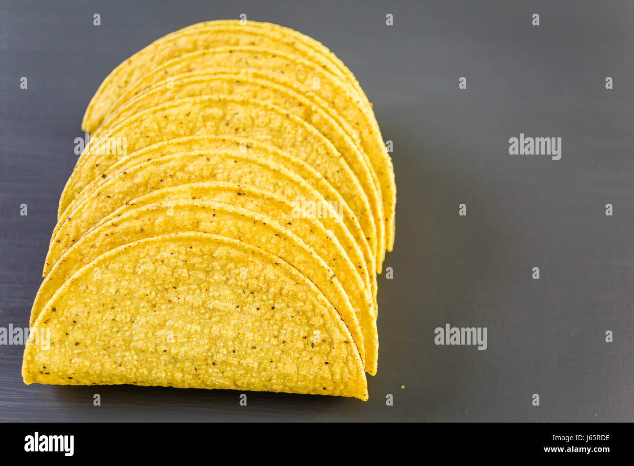 Yellow corn taco shells on a gray background Stock Photo - Alamy