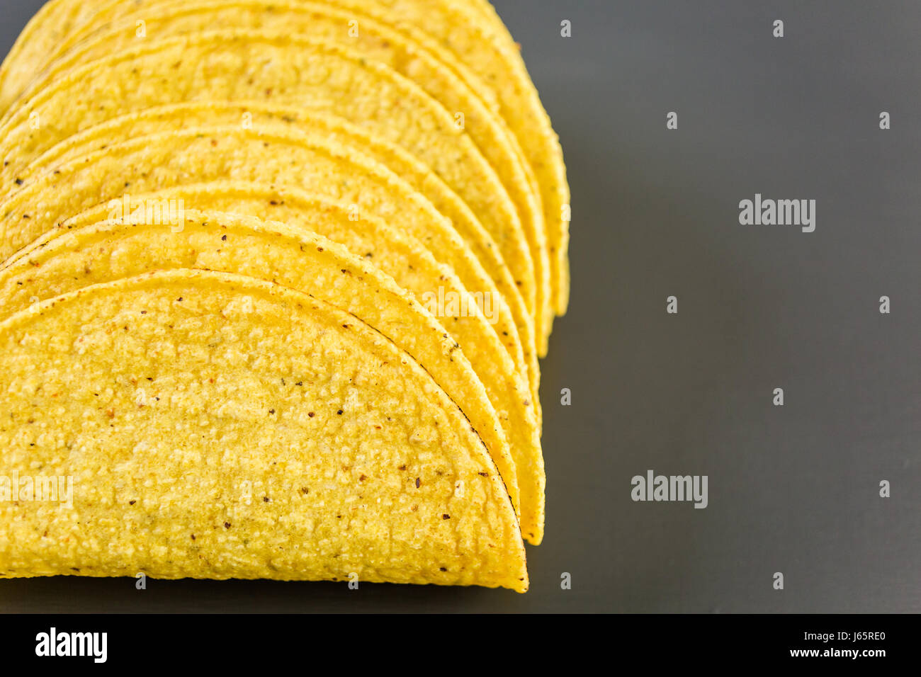 Yellow corn taco shells on a gray background Stock Photo - Alamy