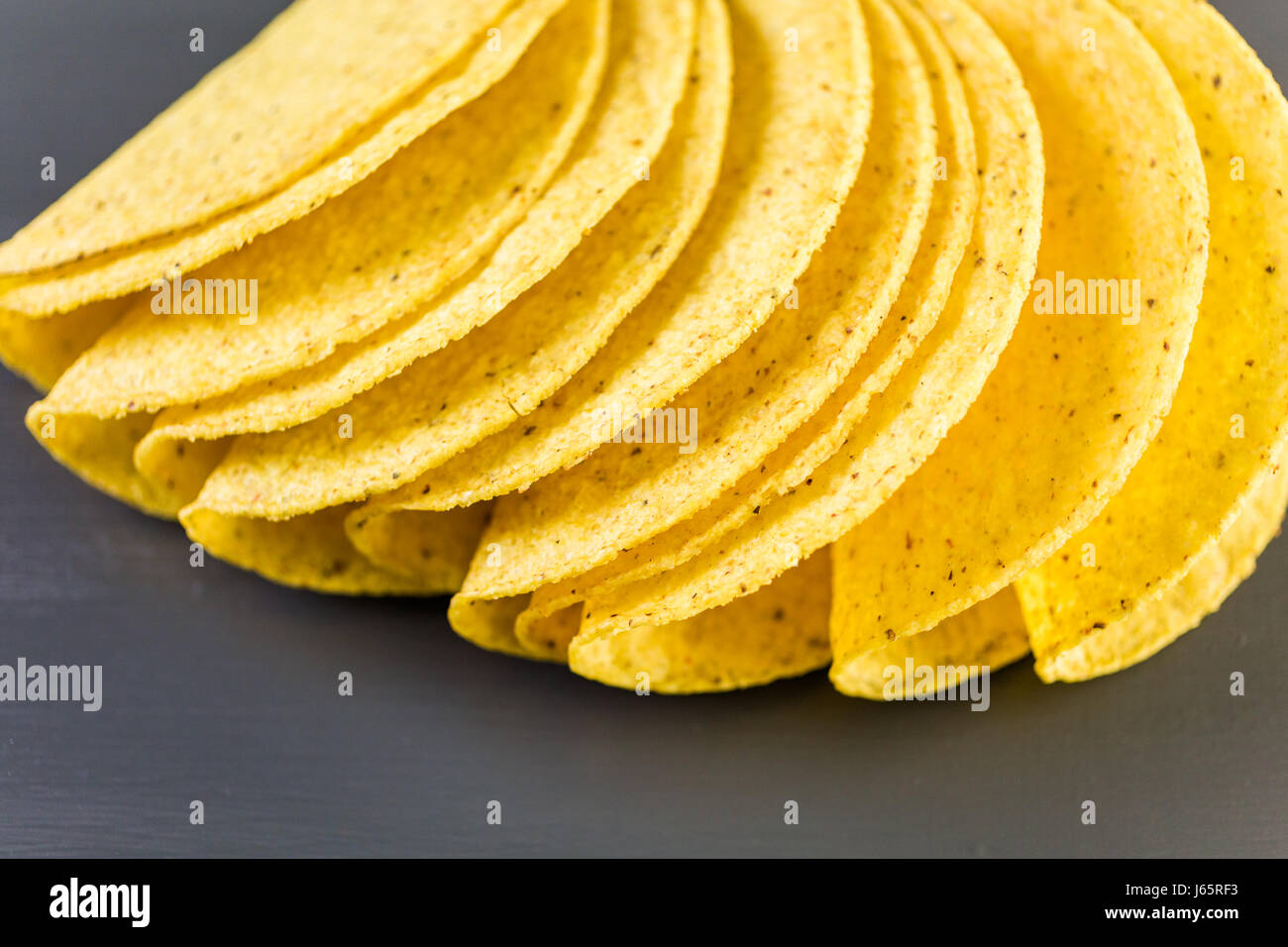 Yellow corn taco shells on a gray background Stock Photo - Alamy