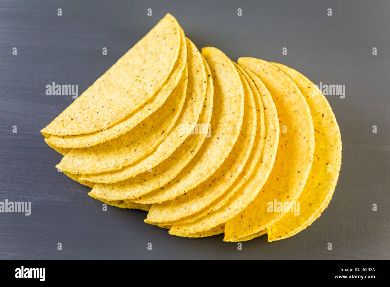 Yellow corn taco shells on a gray background Stock Photo - Alamy