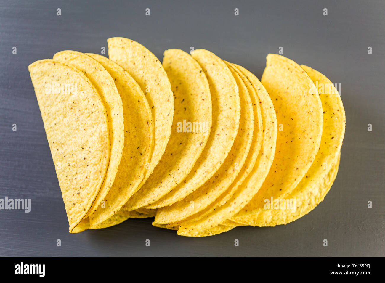 Yellow corn taco shells on a gray background Stock Photo - Alamy