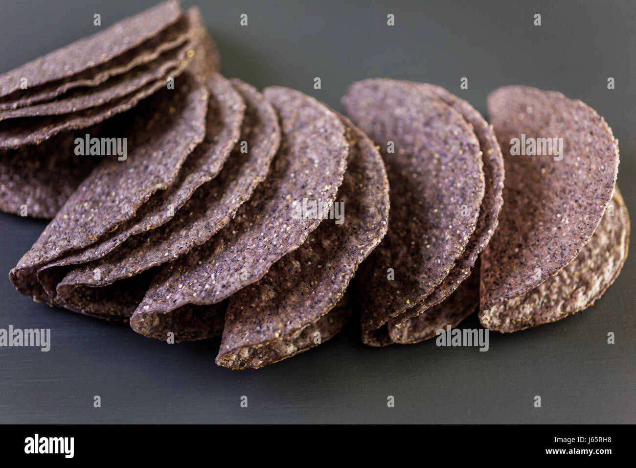 Blue corn taco shells on a gray background Stock Photo - Alamy