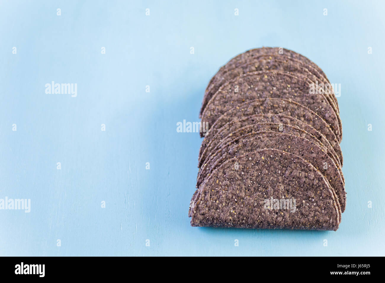 Blue corn taco shells on a blue background Stock Photo - Alamy