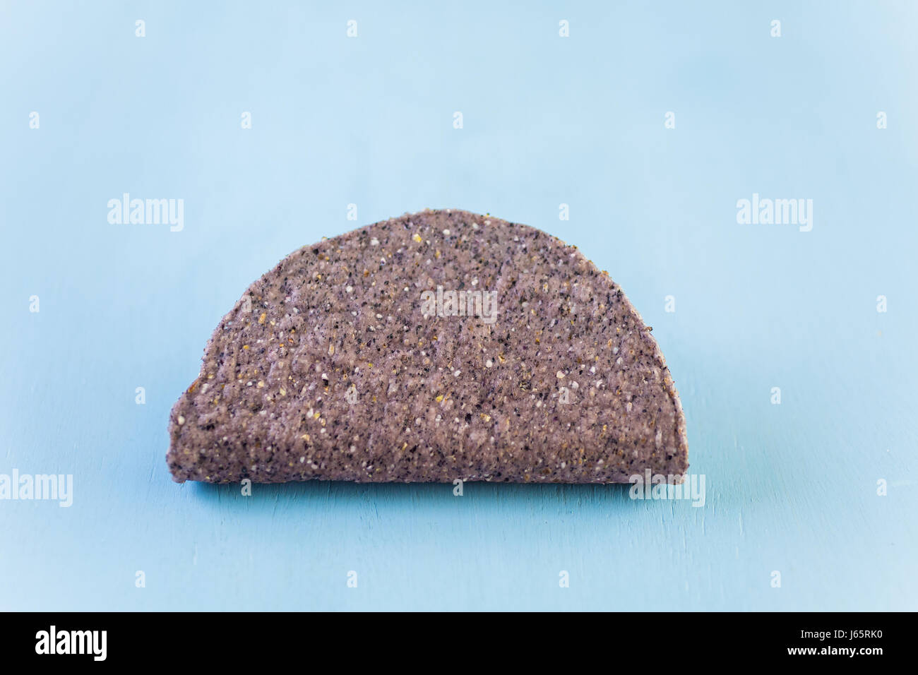 Blue corn taco shells on a blue background Stock Photo - Alamy