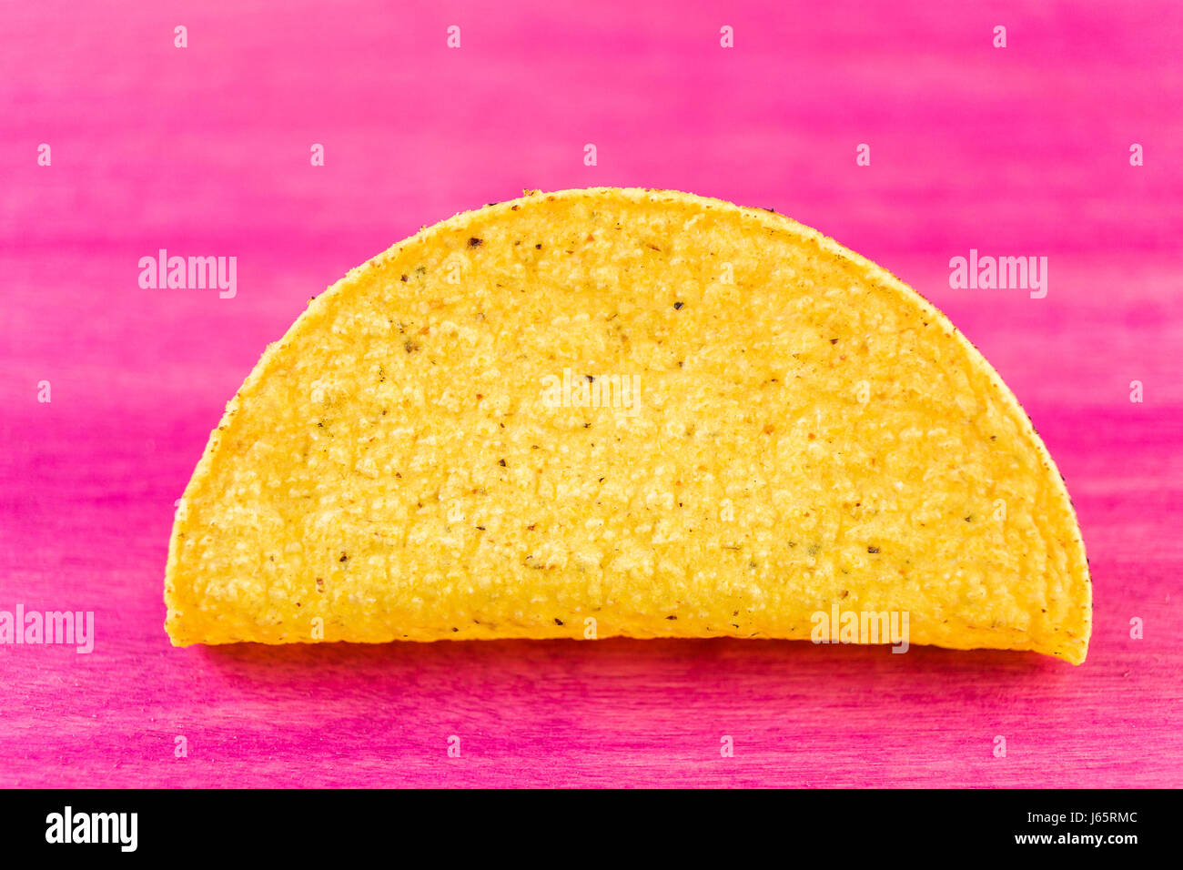 Yellow corn taco shells on a pink background Stock Photo - Alamy