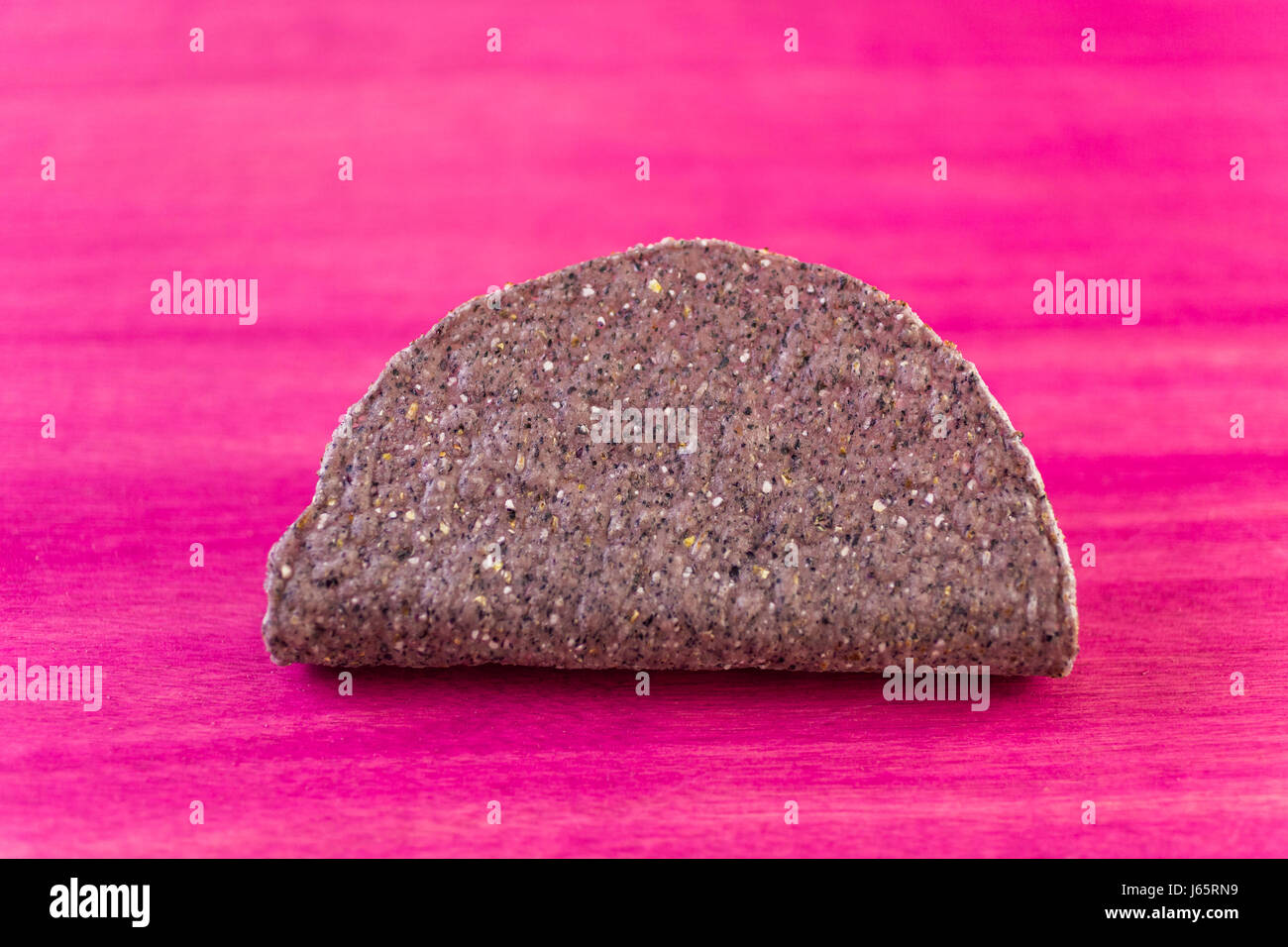 Blue corn taco shells on a pink background Stock Photo - Alamy