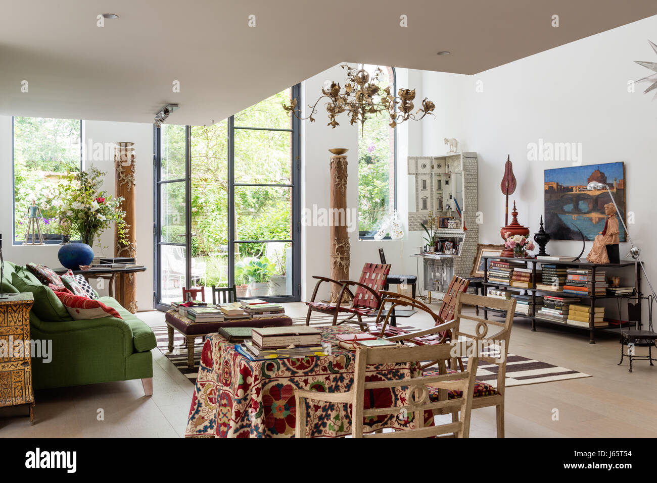 Triple-height living space with rare wooden Austrian columns, books and ...