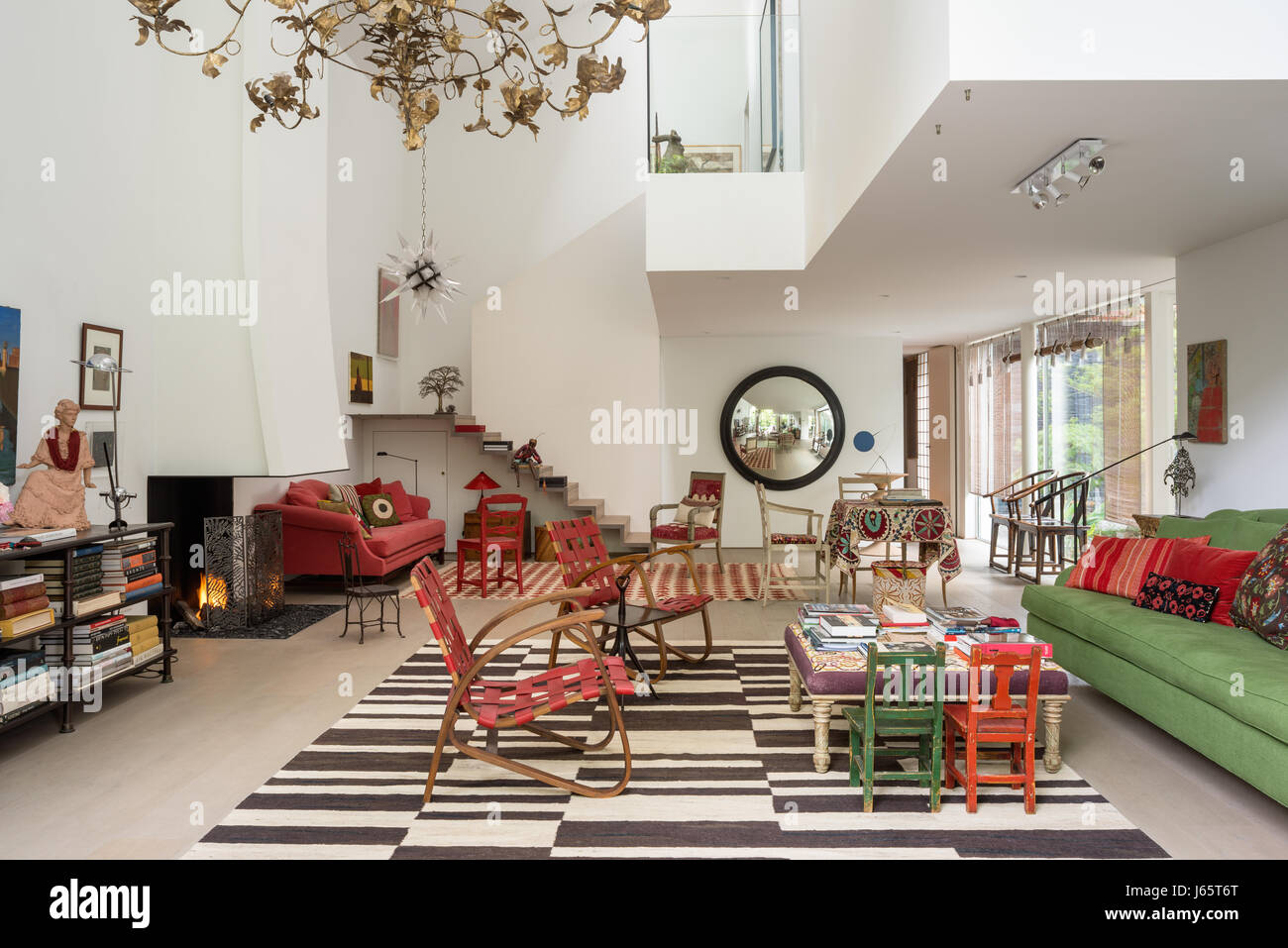 Spacious triple-height living space with gold paper chandelier by ...