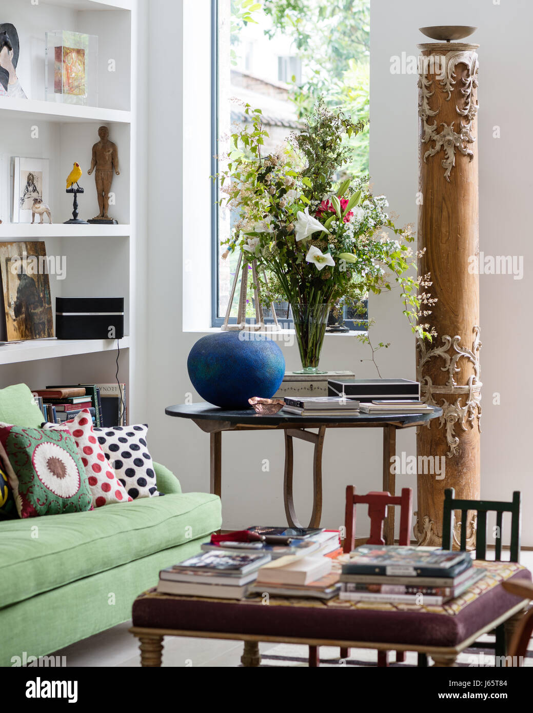 One of a pair of rare wooden Austrian columns with side table at window ...