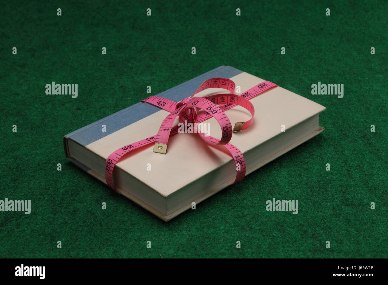 Book depicting weight management on a green background Stock Photo - Alamy