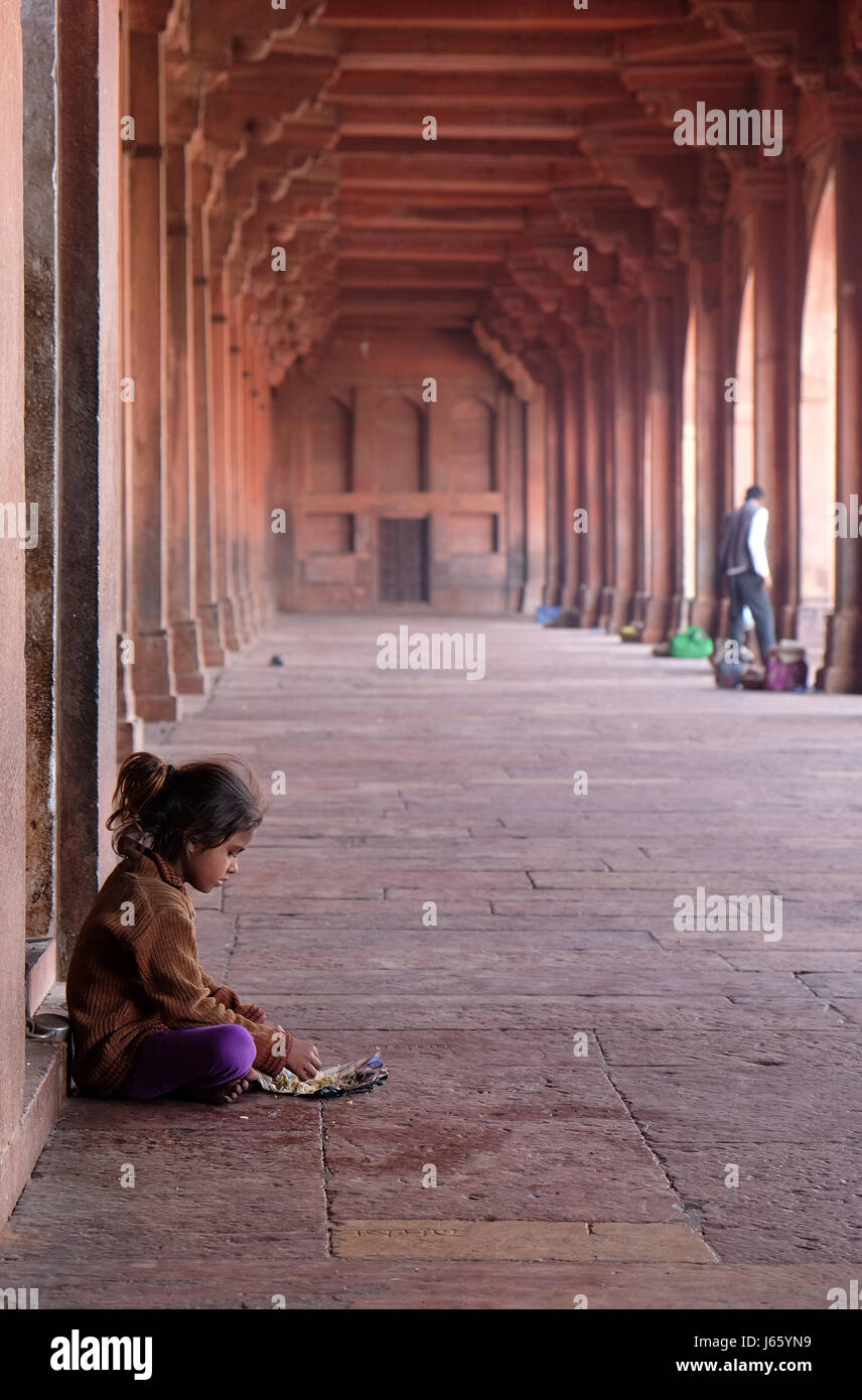 A poor girl eating in Fatehpur Sikri complex, Uttar Pradesh, India on ...